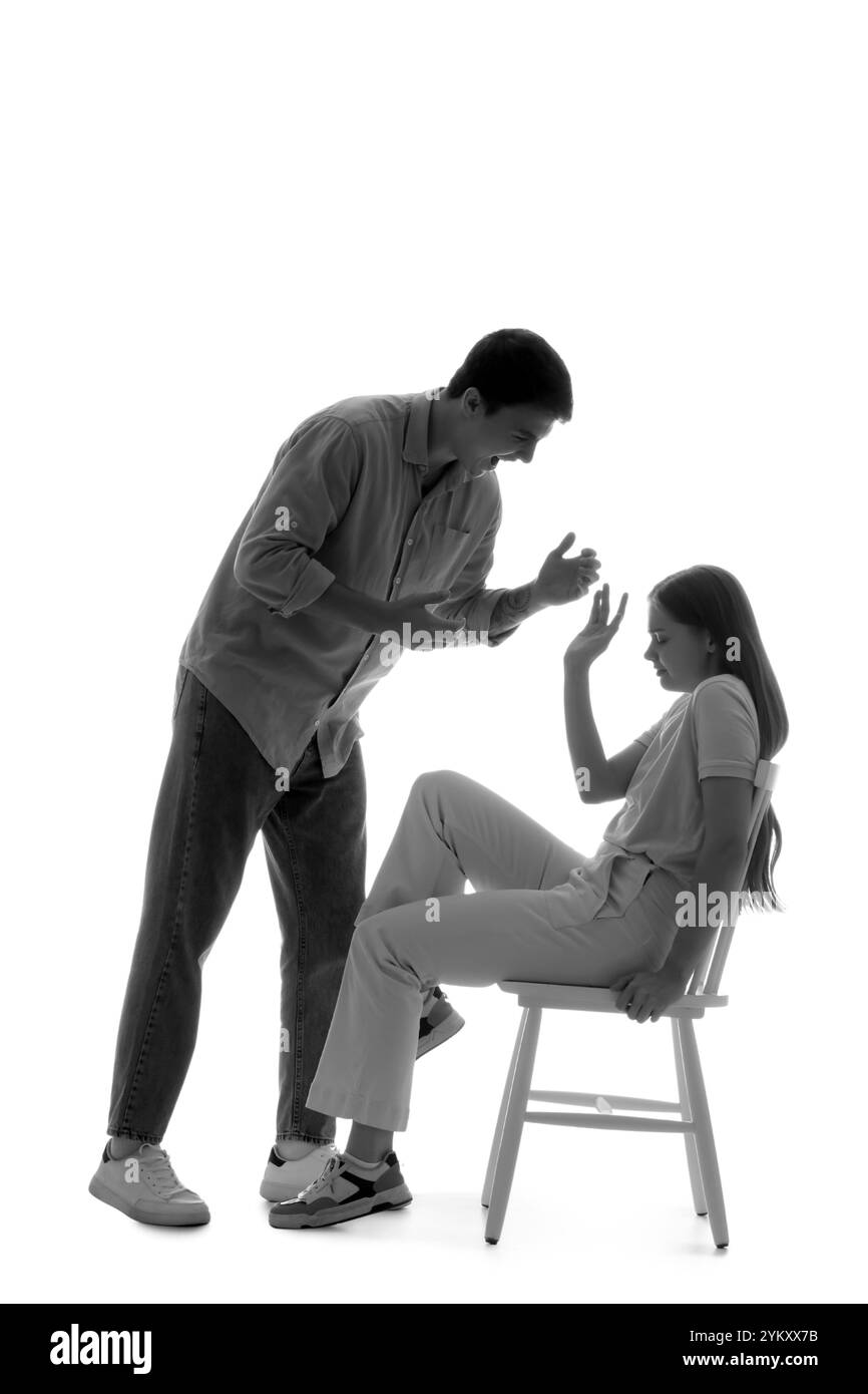 Silhouette of angry man shouting at woman on white background. Domestic ...