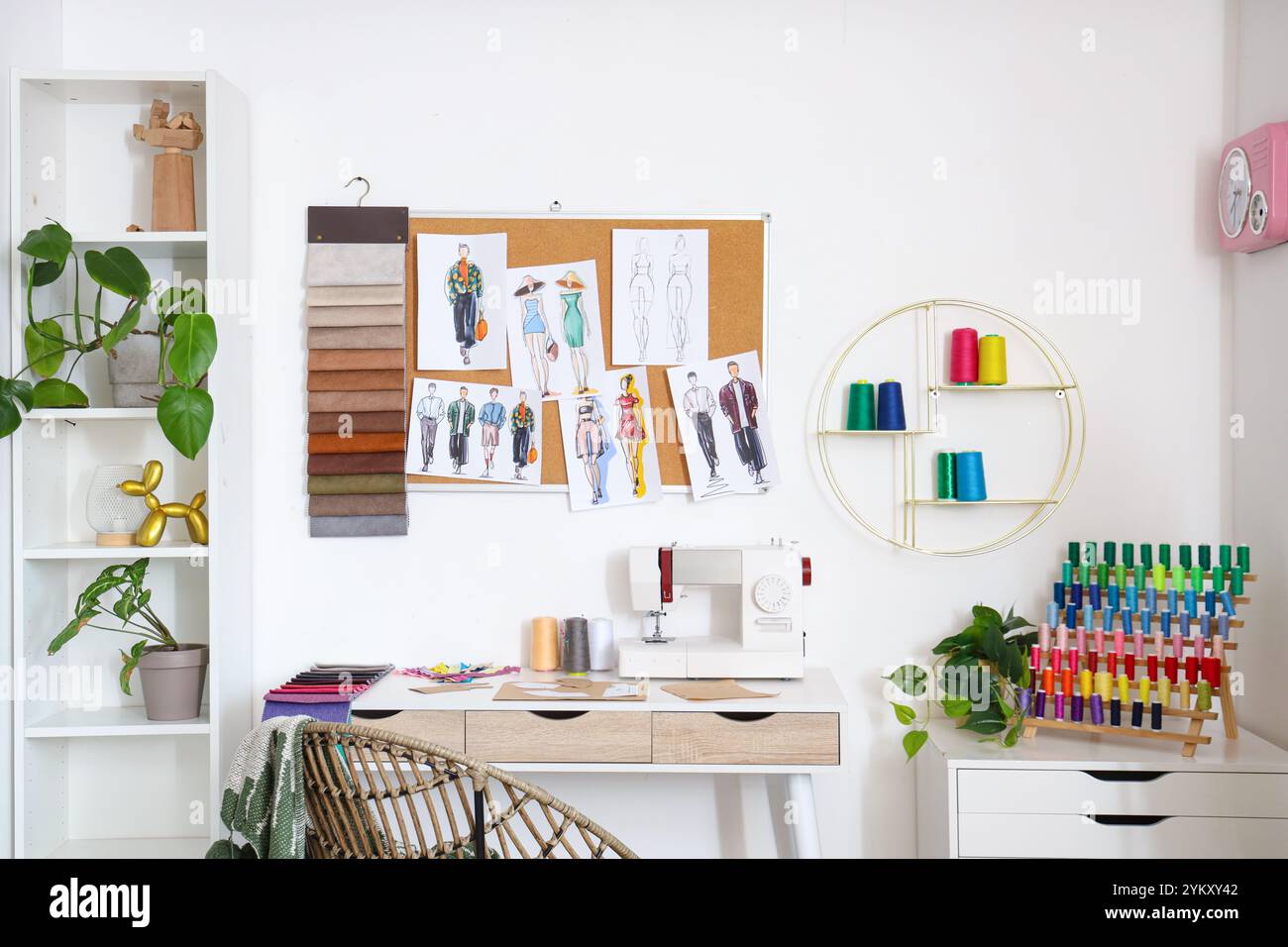 Interior of light atelier with tailor's workplace, shelf unit and pin ...