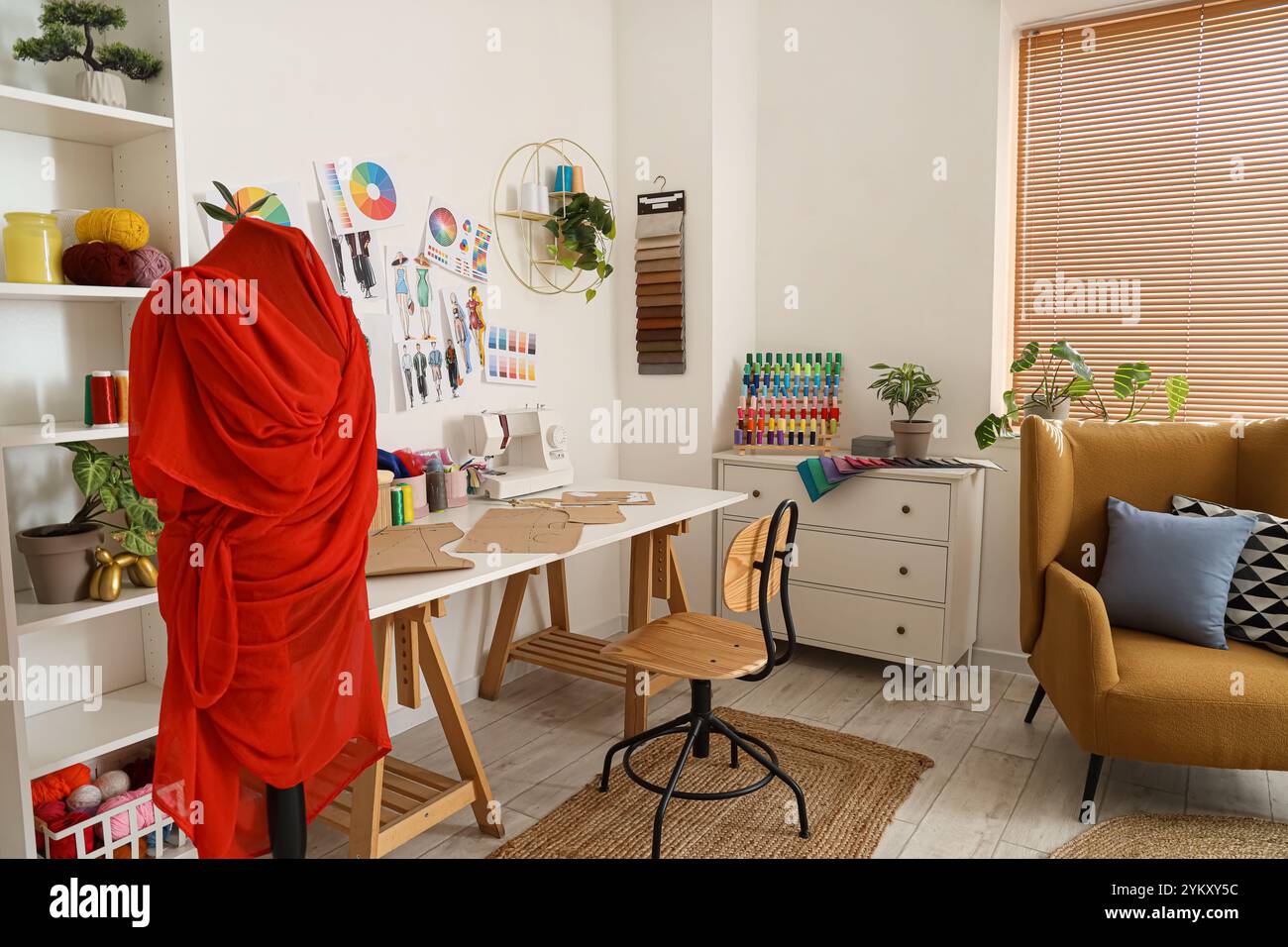 Interior of light atelier with tailor's workplace, mannequin and ...