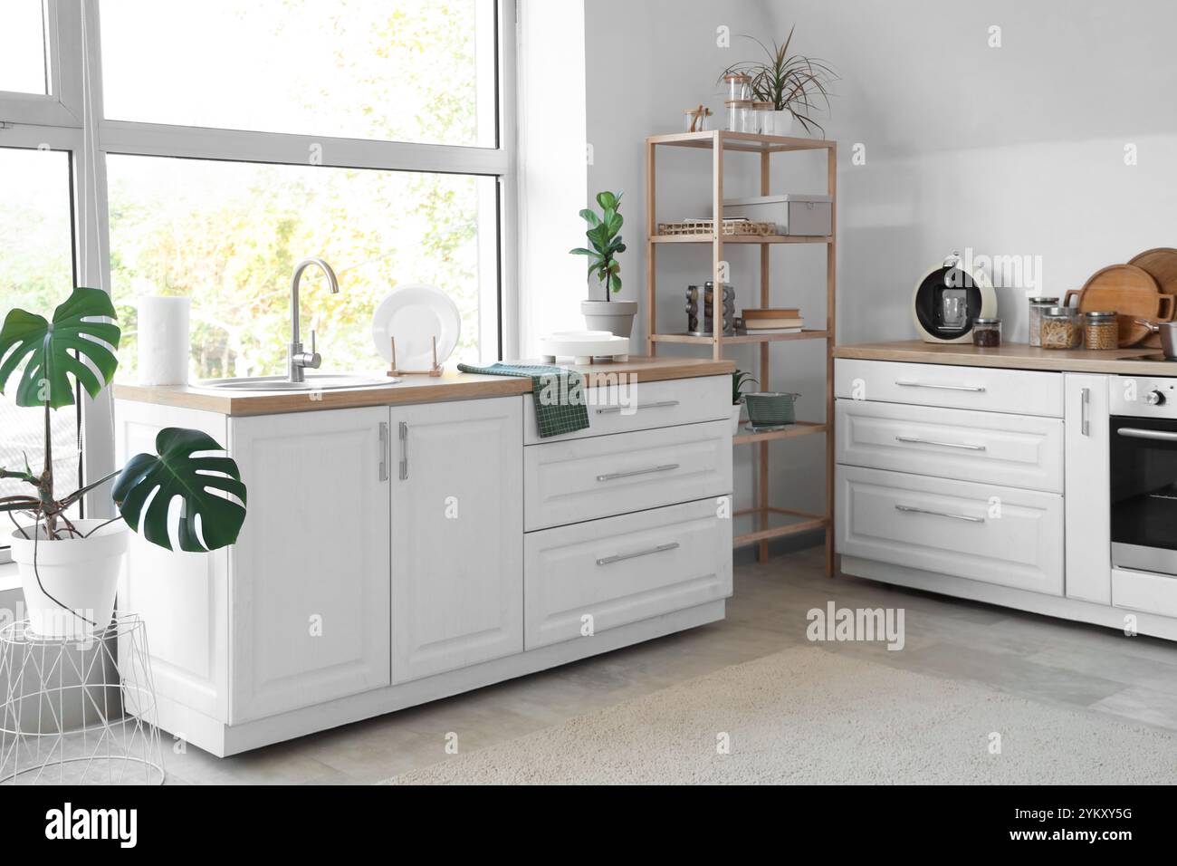 Interior of kitchen with white counters, shelf unit and utensils Stock ...