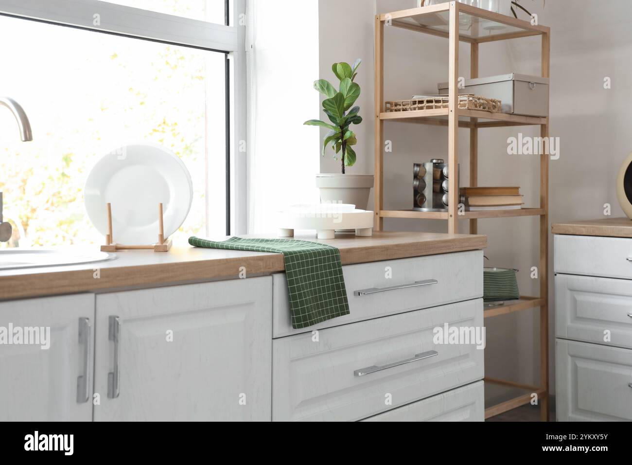 Interior of kitchen with white counters, shelf unit and utensils Stock ...