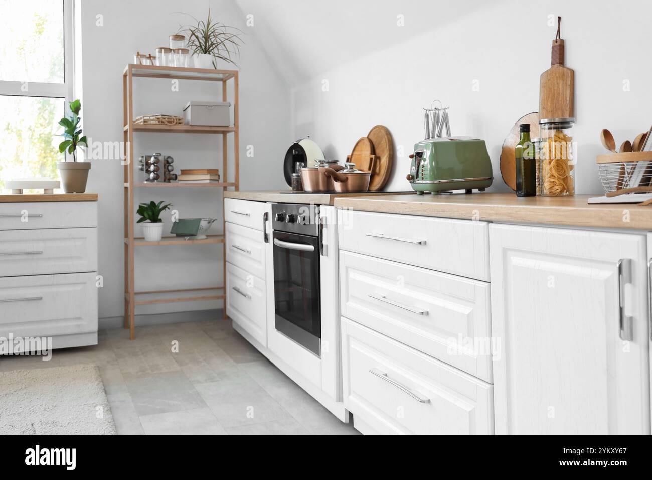 Interior of kitchen with white counters, shelf unit and utensils Stock ...