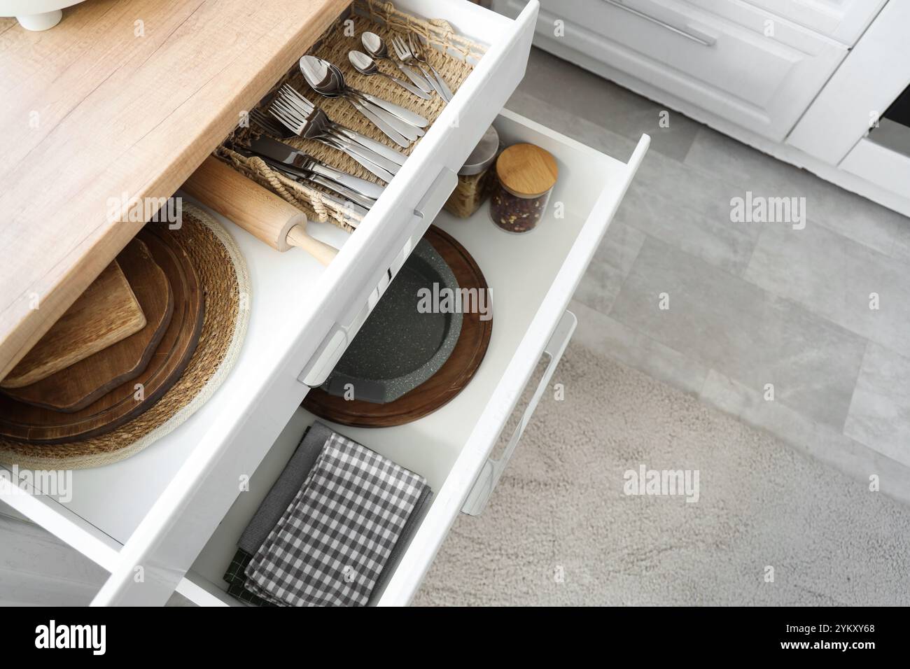 Open drawers with utensils in kitchen, closeup Stock Photo - Alamy
