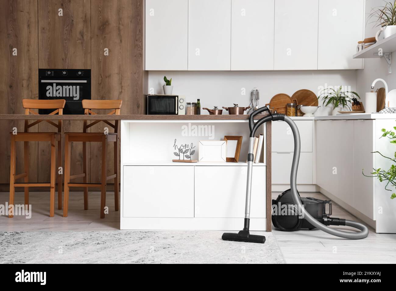 Interior of kitchen with vacuum cleaner, table and counters Stock Photo ...