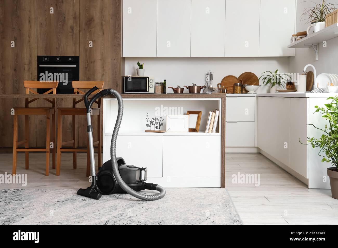 Interior of kitchen with vacuum cleaner, table and counters Stock Photo ...