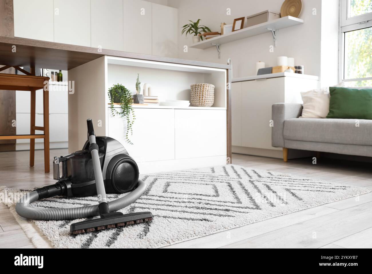 Interior of kitchen with vacuum cleaner, table and counters Stock Photo ...