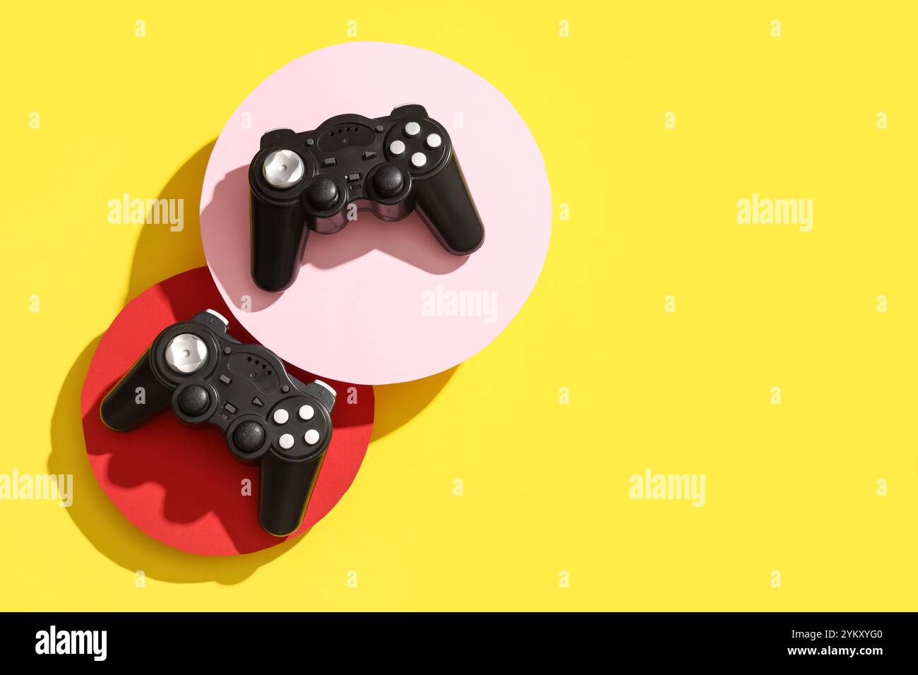 Composition with modern game pads on yellow background Stock Photo - Alamy