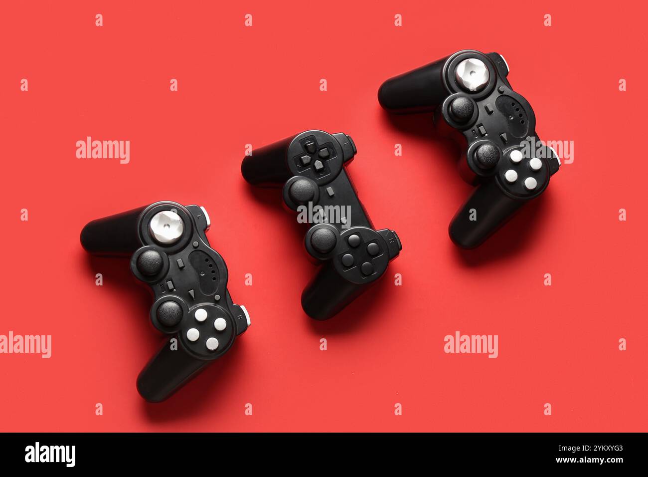 Modern game pads on red background Stock Photo - Alamy