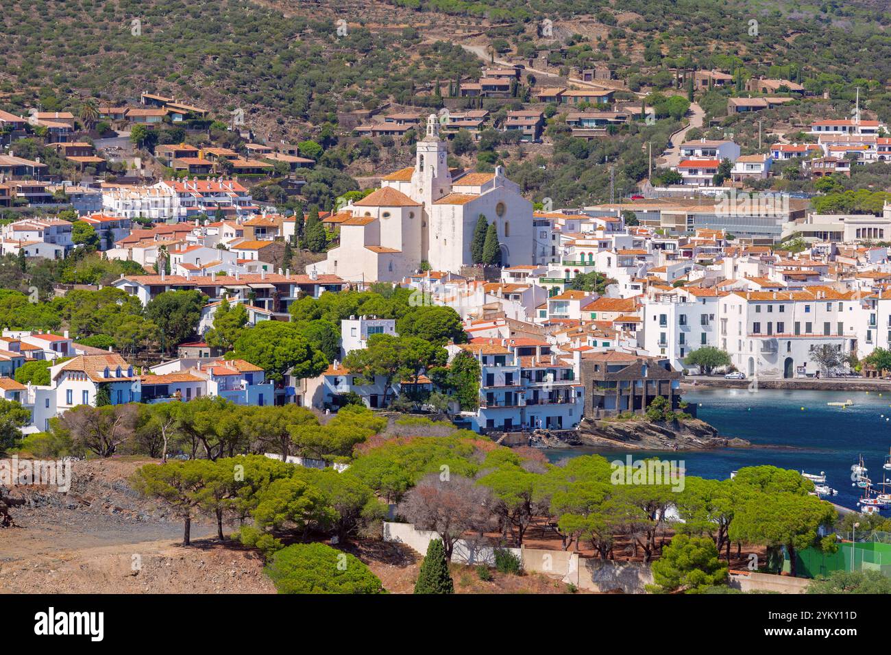 View of the coastal town of Cadaques with the historic white church of ...