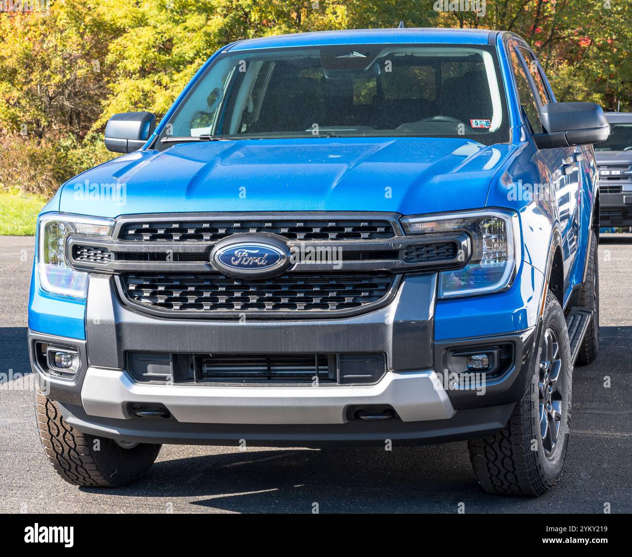 A blue, four door Ford Ranger pickup truck for sale at a dealership in ...