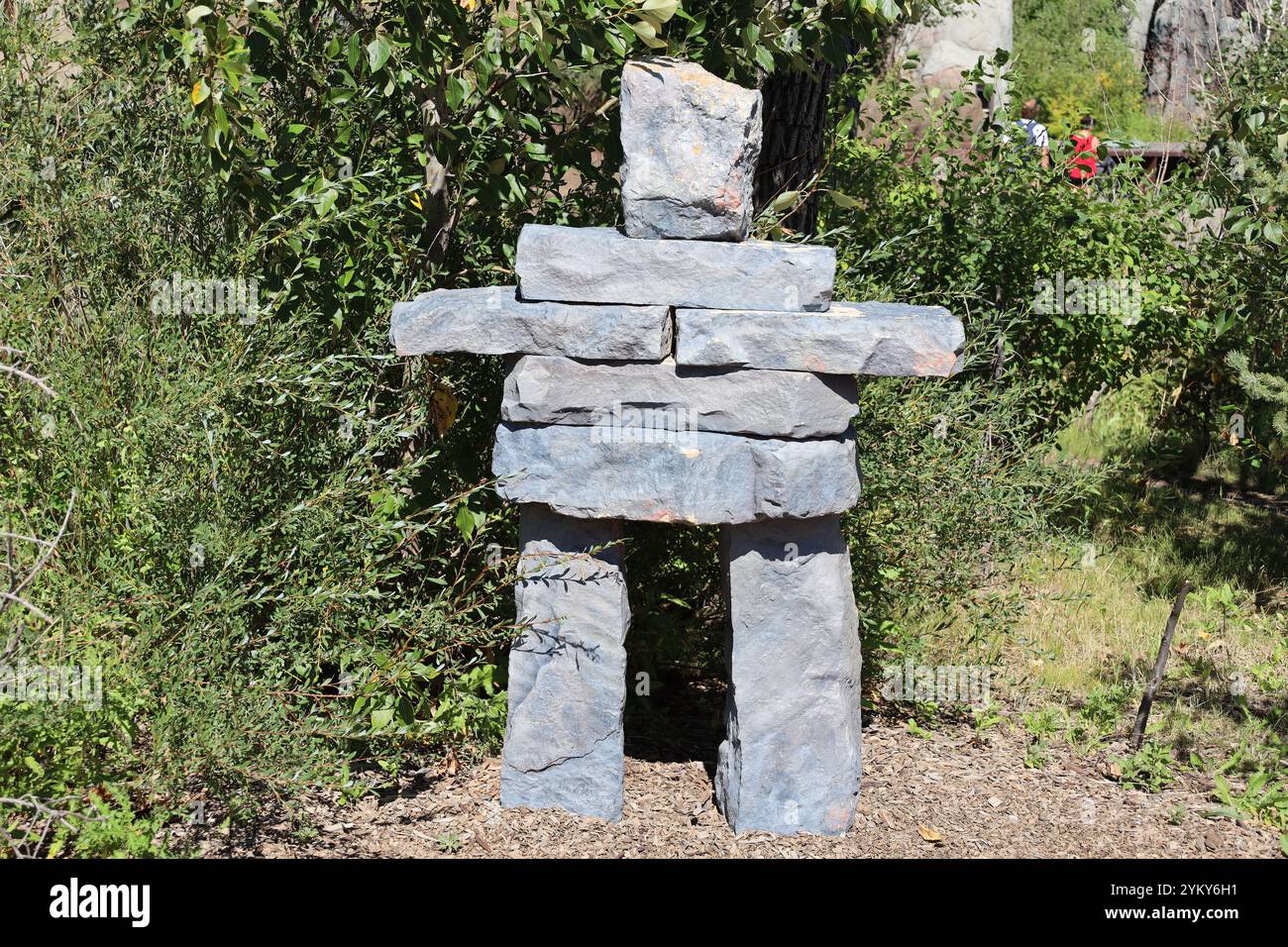 large inukshuk against green forest backdrop Stock Photo - Alamy