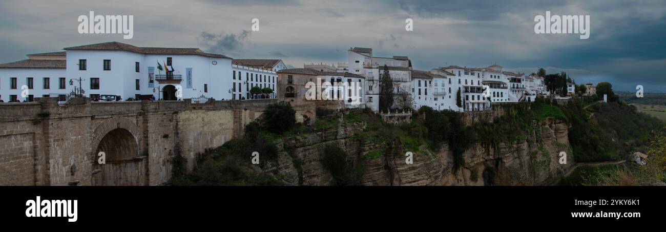 Cliff side view of Ronda in Spain, with white buildings built onto of ...