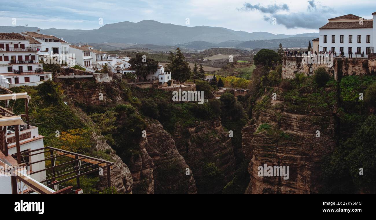 Cliff side view of Ronda in Spain, with white buildings built onto of ...