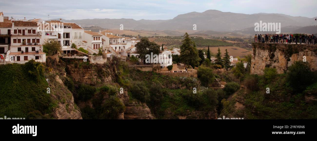 Cliff side view of Ronda in Spain, with white buildings built onto of ...