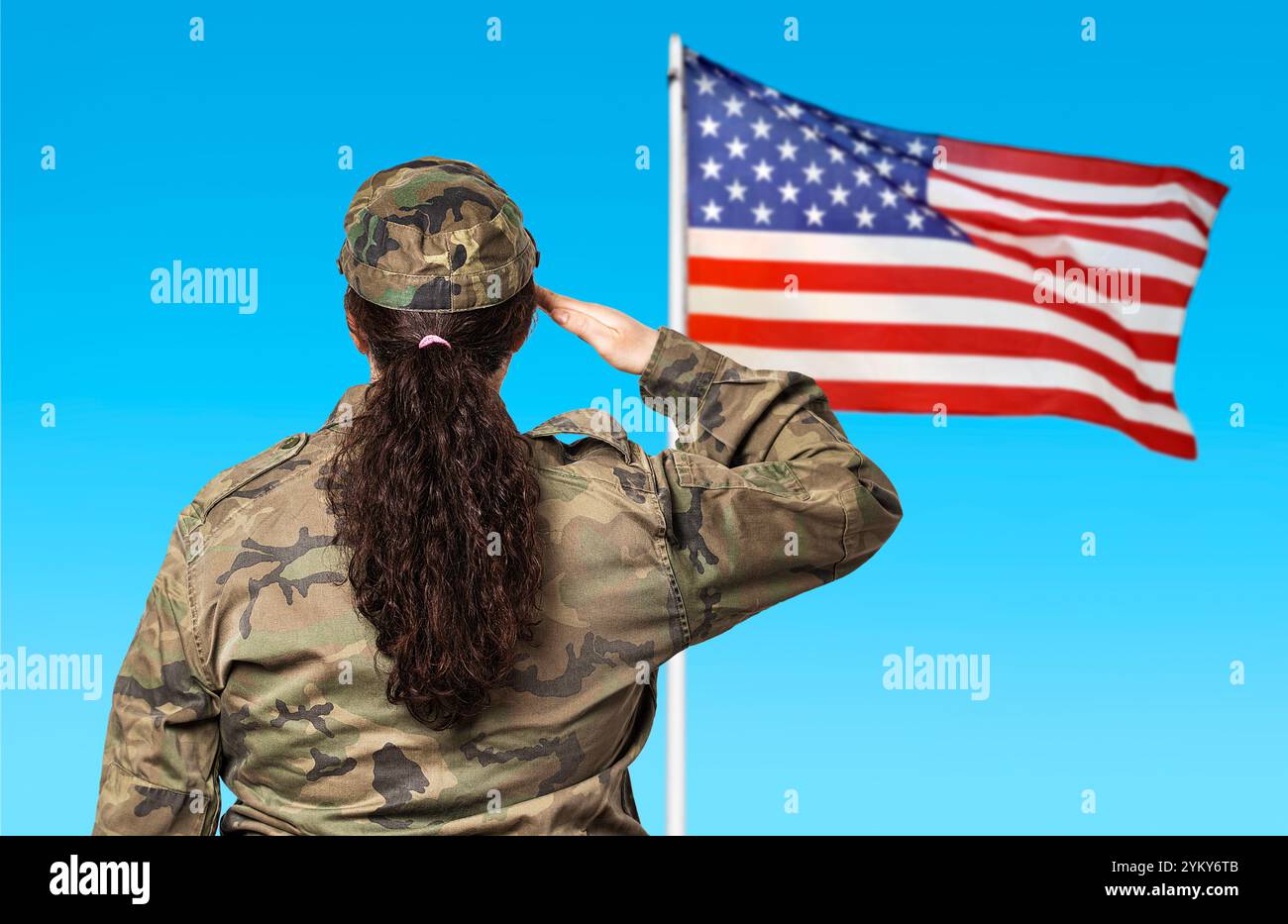 Rear view of young female soldier standing in front of american flag ...