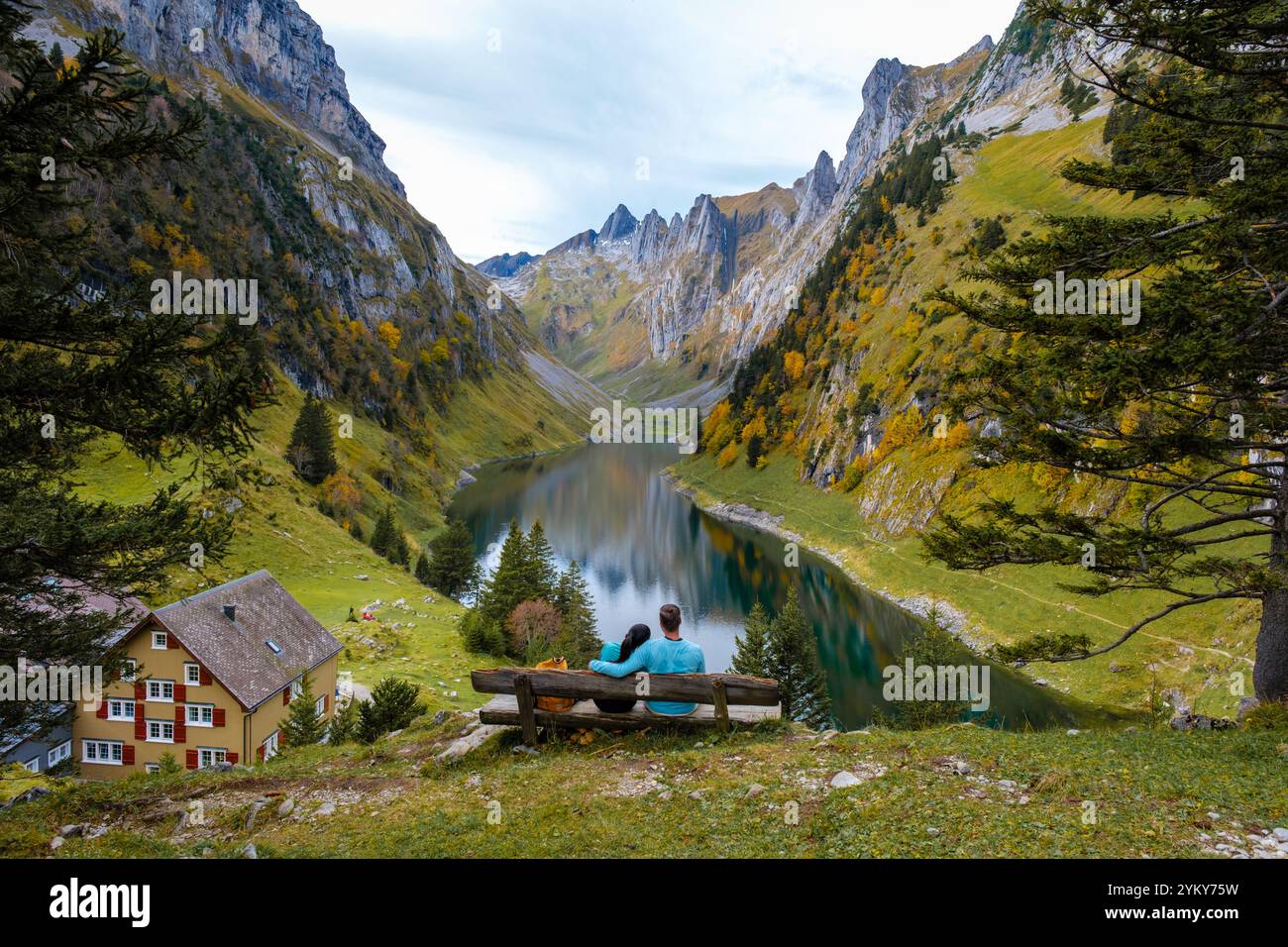 Couples sit on a bench, admiring the breathtaking Falensee lake ...