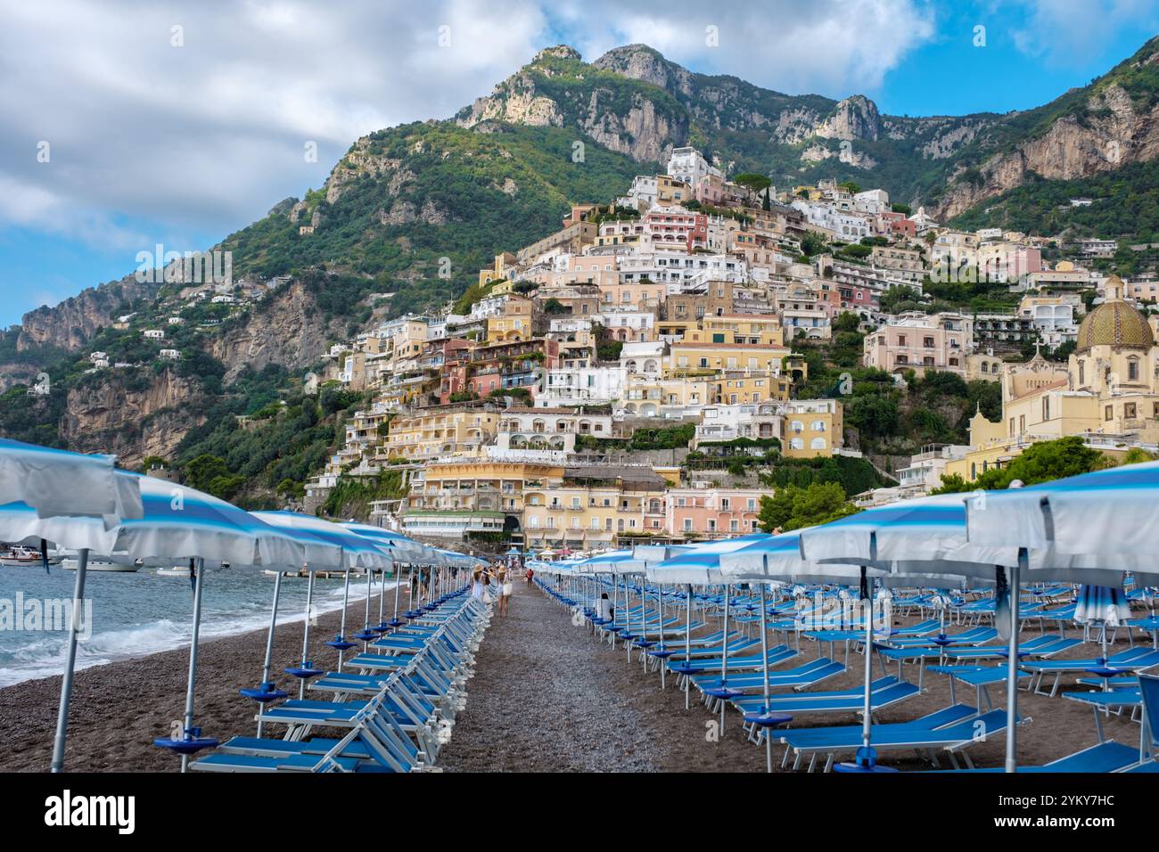 Visitors enjoy a peaceful day on the sandy beach of Positano ...
