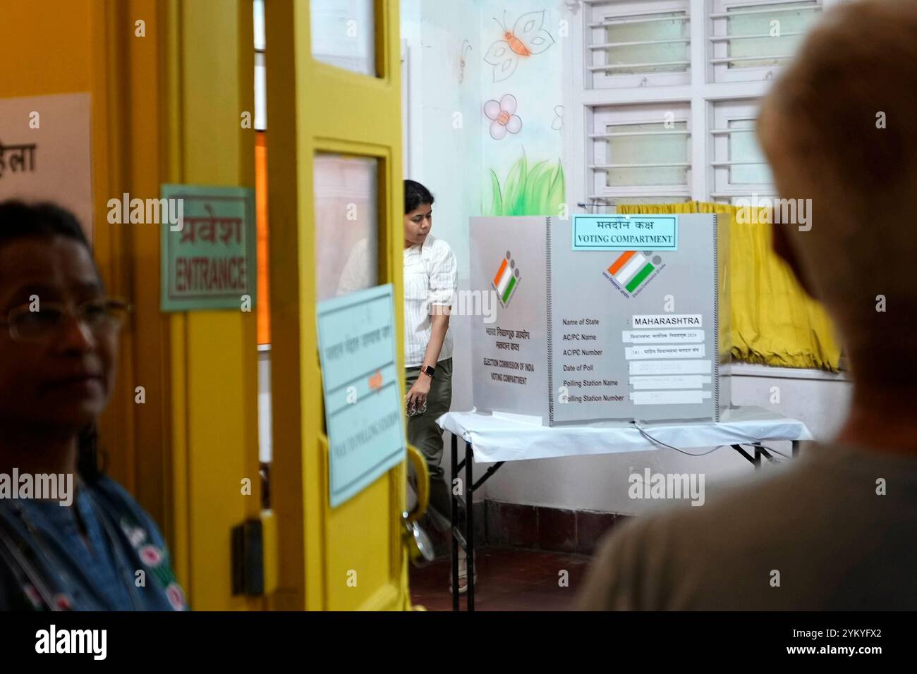 A woman walks out after casting her vote during Maharashtra state ...