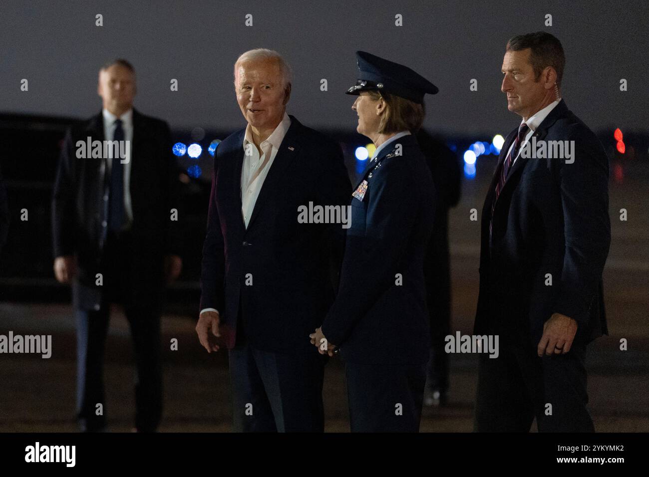President Joe Biden, second from left, is greeted by Col. Angela Ochoa ...