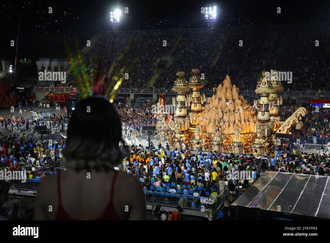 A spectator watches the Vila Isabel samba school pass by from the ...