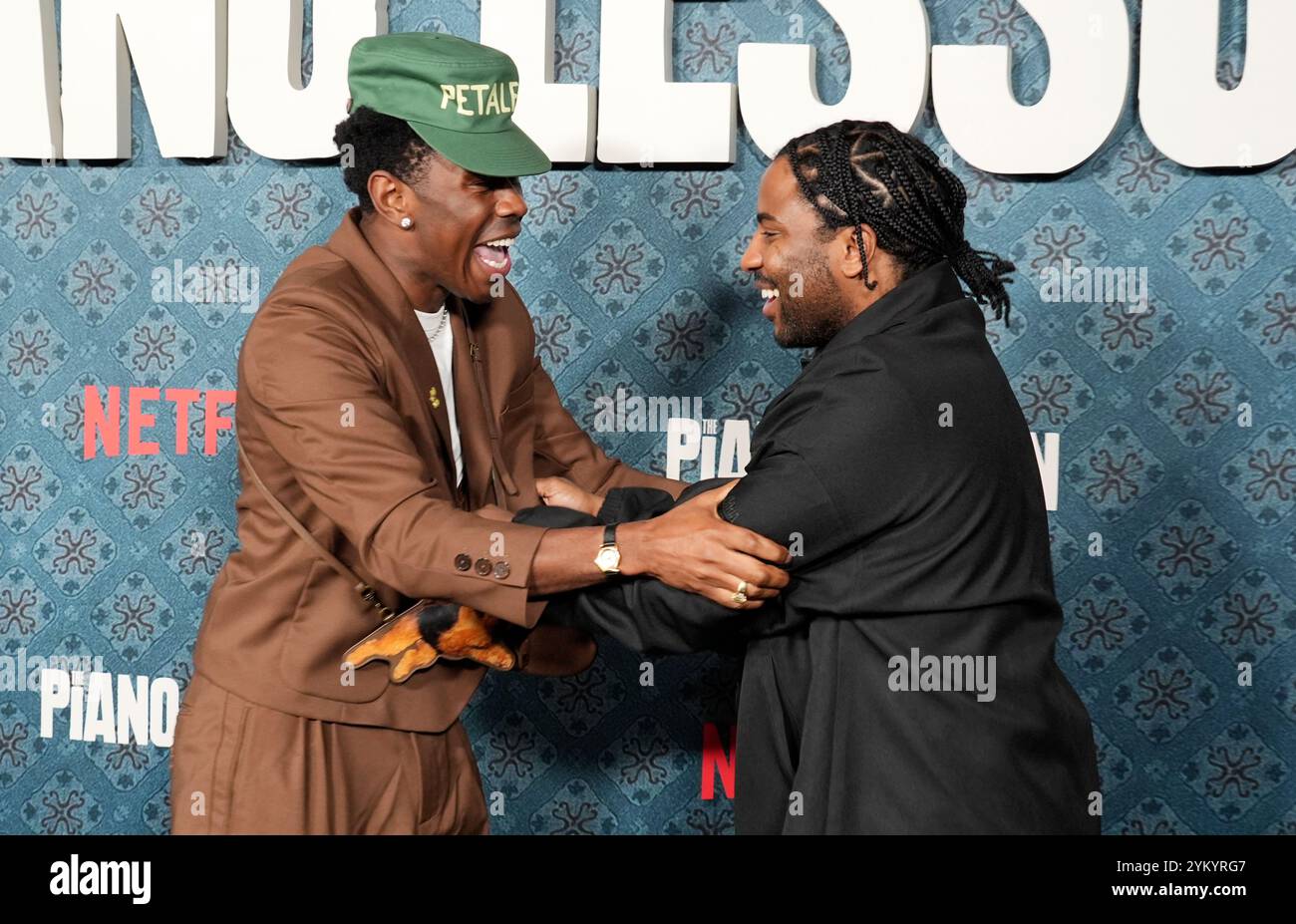 Tyler, The Creator, left, greets Malcolm Washington, director and co ...