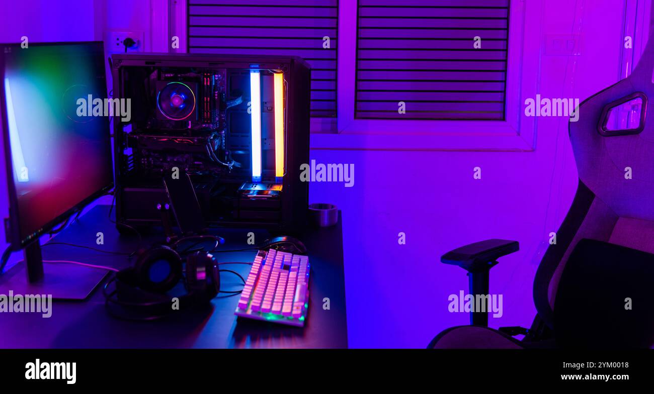 A computer setup with a purple light dark background, games ...
