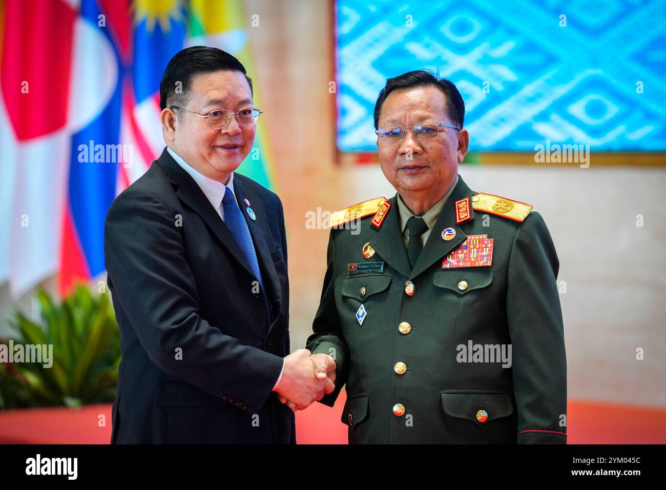 Laos' Defence Minister Chansamone Chanyalath, right, greets ASEAN ...