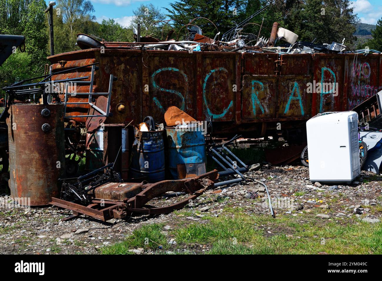 Scrap collection, an old, open top freight wagon and some 44 gallons ...