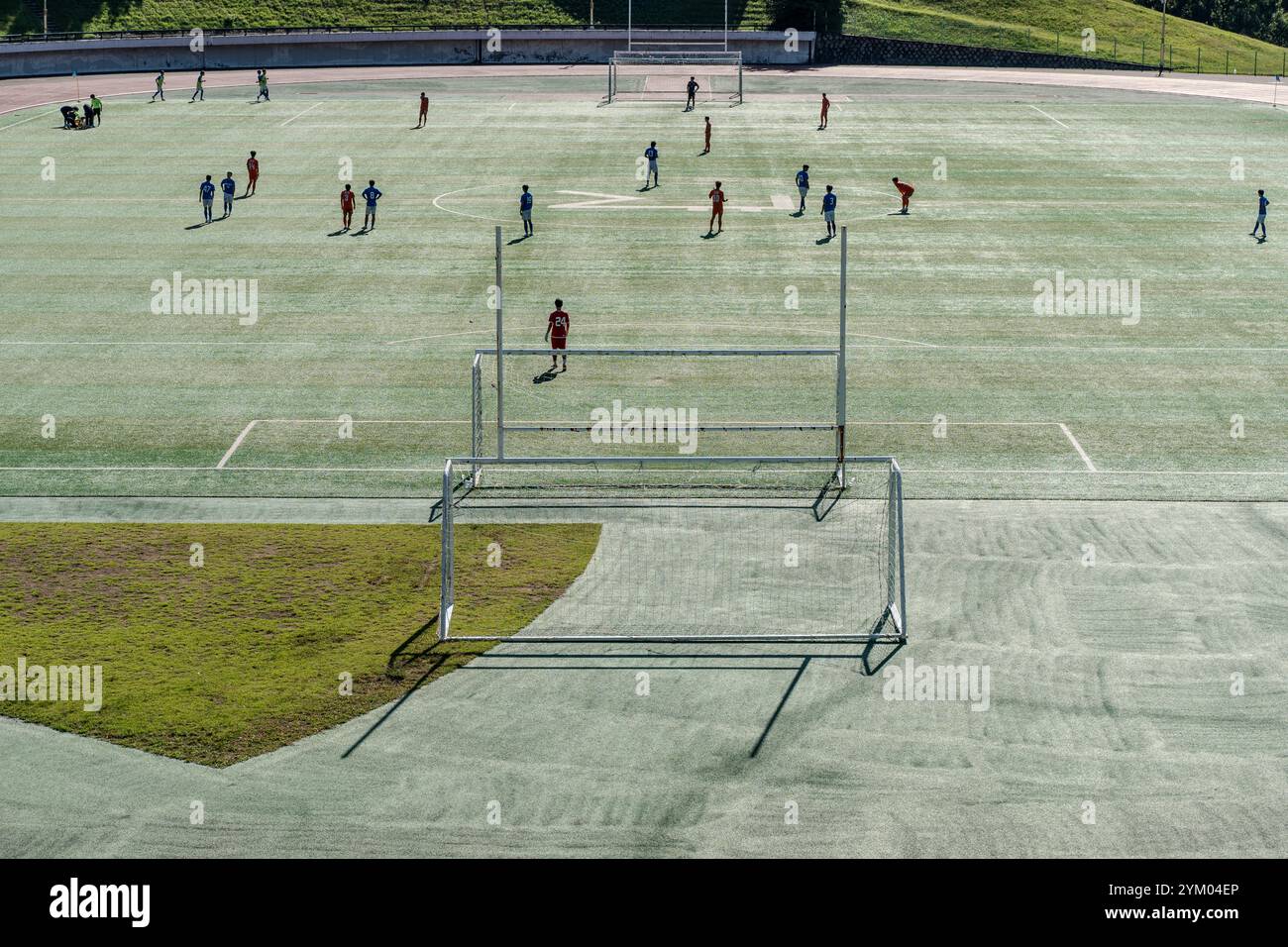 A soccer match in progress on the vibrant green field of Seoul National ...