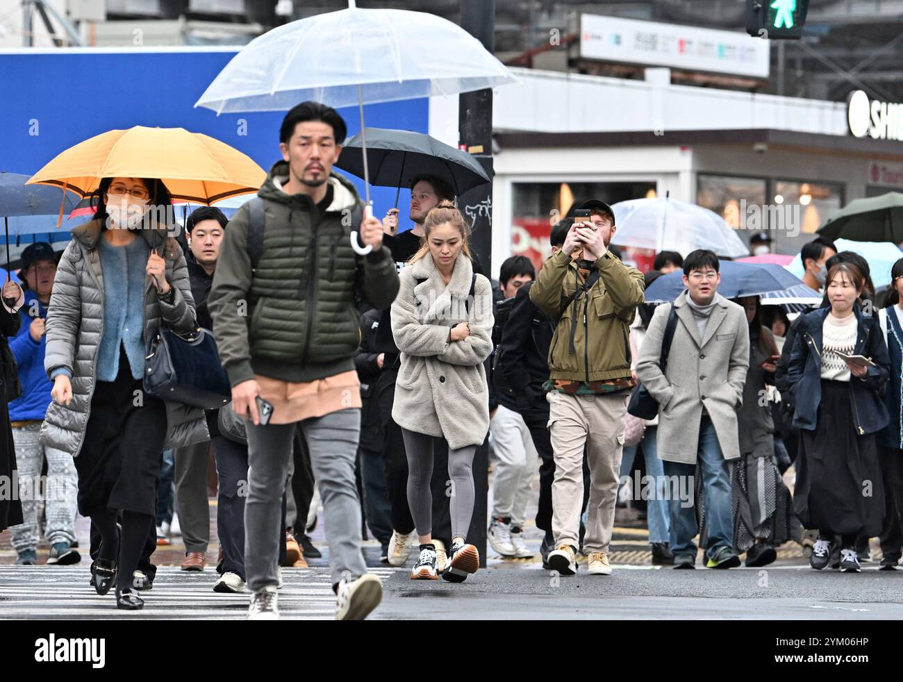 People walk at Shibuya Crossing amid the temperature is low in Tokyo on ...