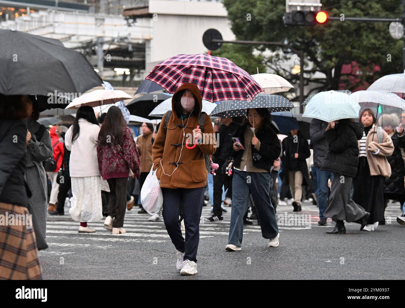 People walk at Shibuya Crossing amid the temperature is low in Tokyo on ...