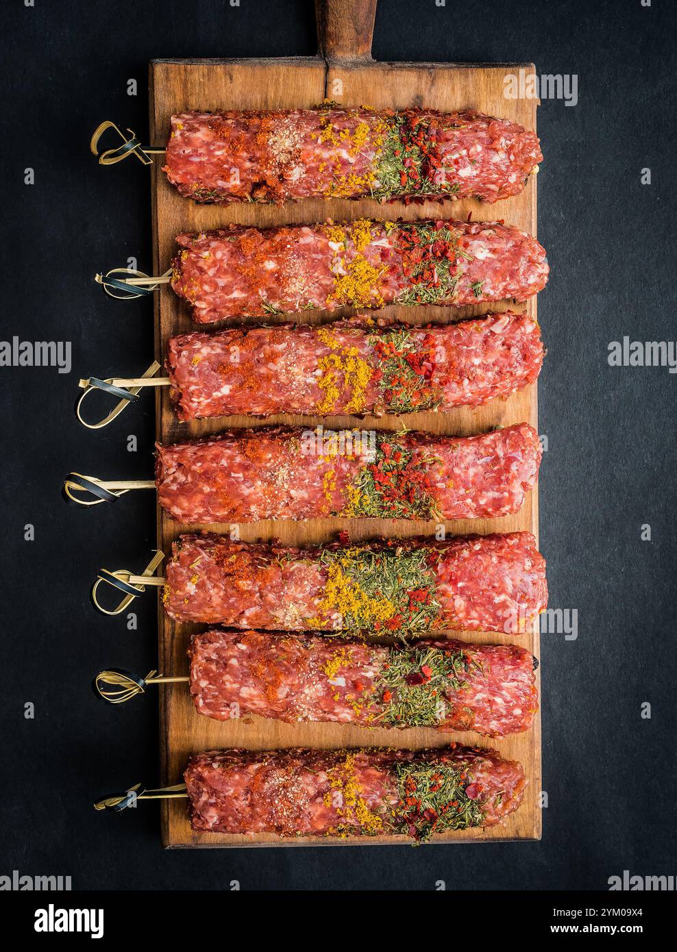 Raw kebab with spices on a board Stock Photo - Alamy