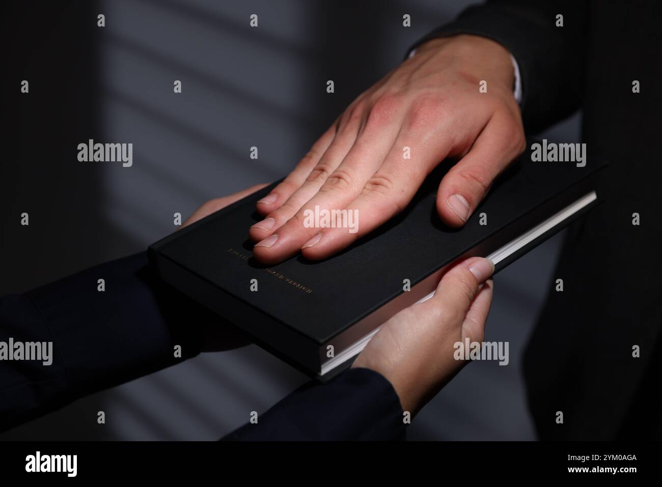 Man taking oath with his hand on Bible indoors, closeup Stock Photo - Alamy