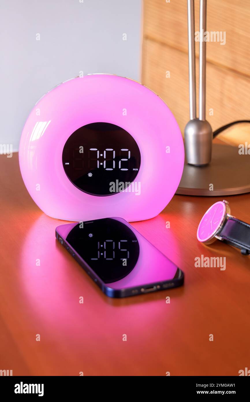 A pink digital alarm clock displaying 7.02 am Stock Photo - Alamy