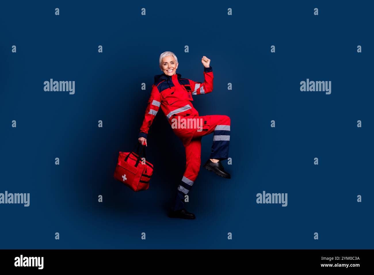 Full body photo of senior woman ambulance worker first aid kit bag ...