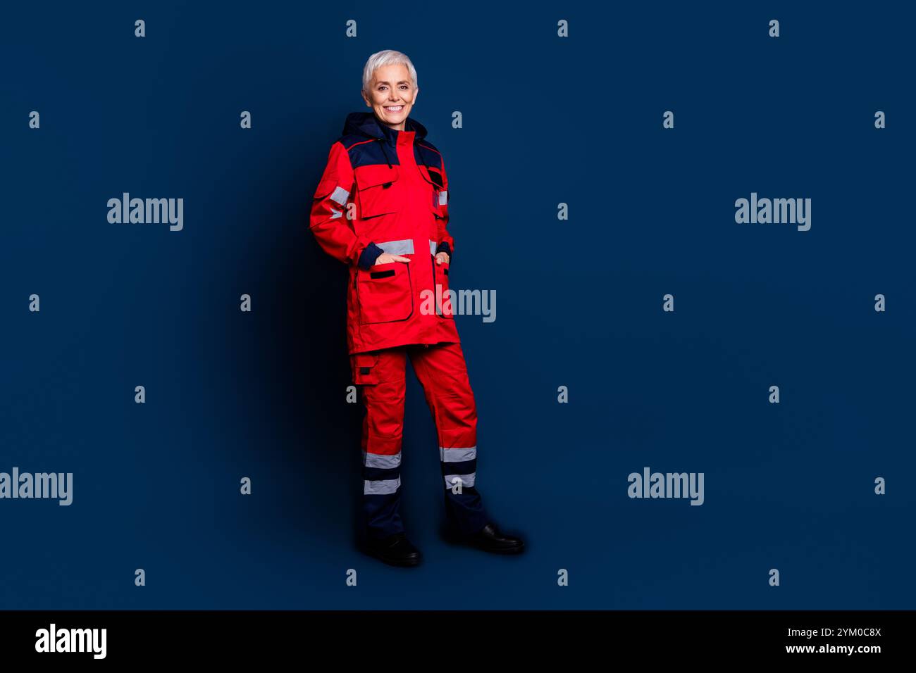 Full body photo of nice senior woman stand hands pockets wear uniform ...