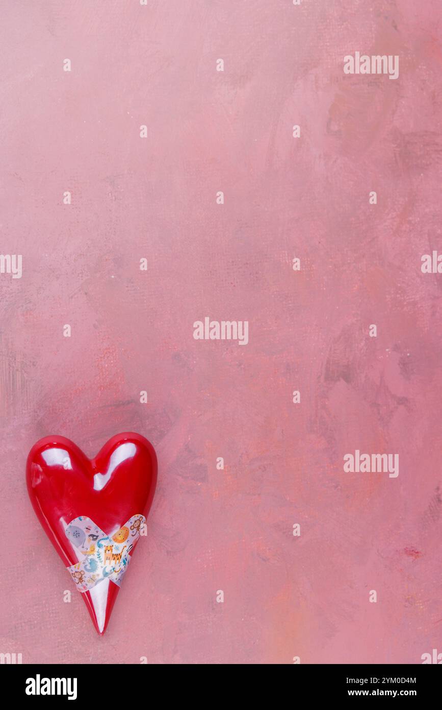 Red and white hearts with bandages and white pills on a red cement ...