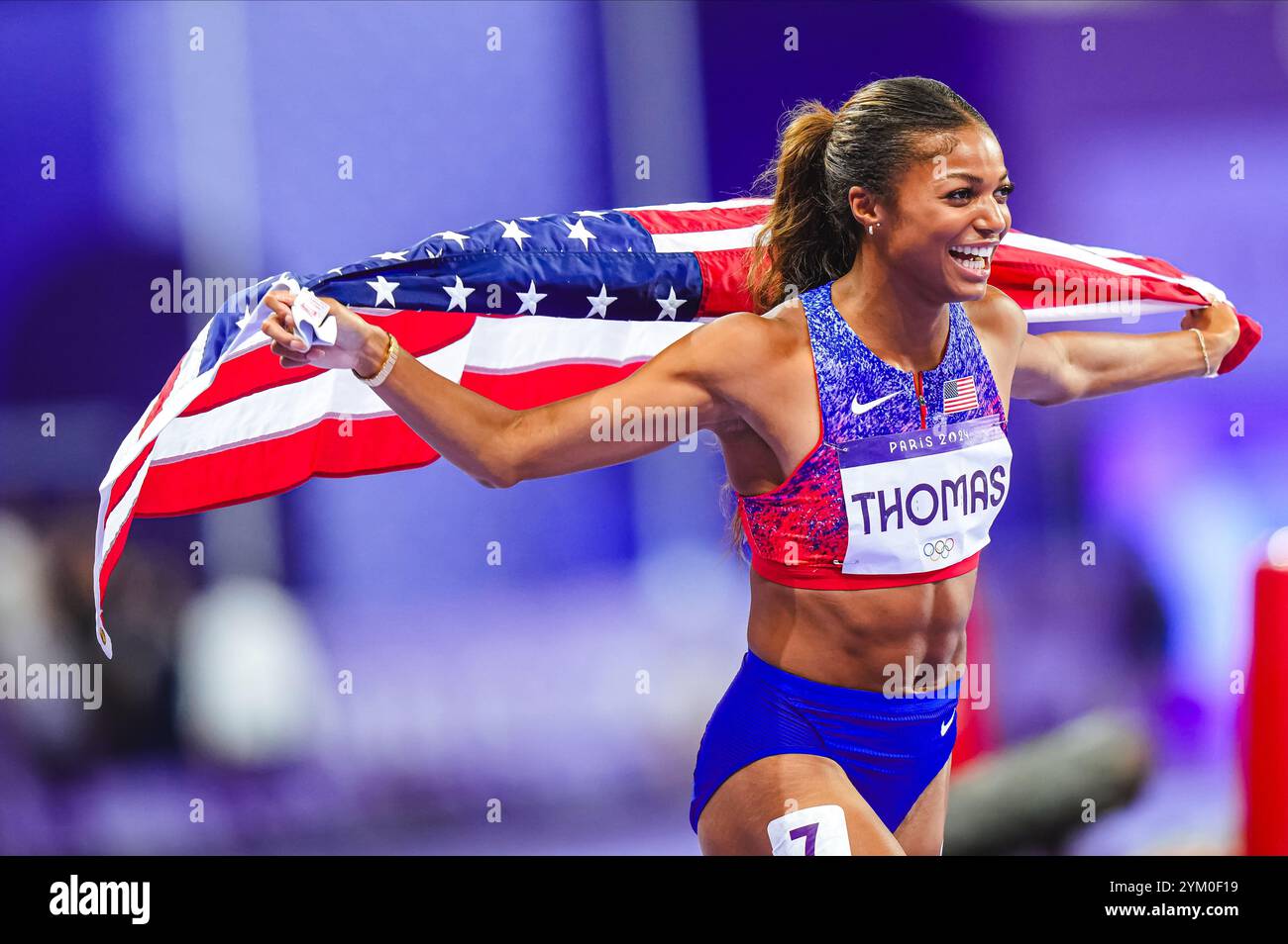 Gabrielle Thomas celebrating with her country's flag in the 200 meters ...