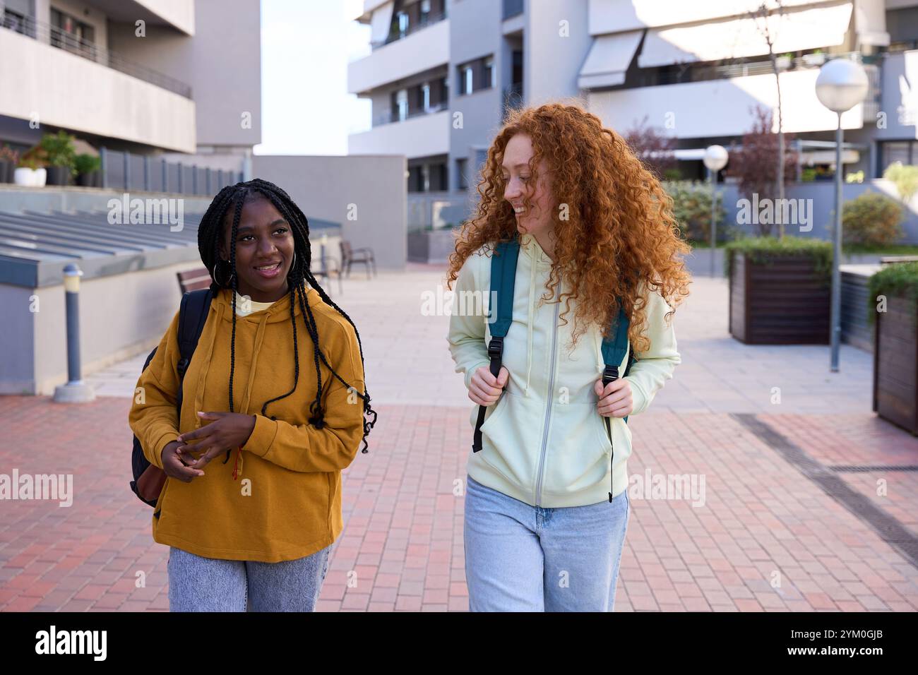 University students walking and talking on campus Stock Photo - Alamy