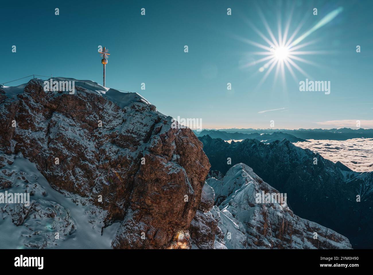View of the summit cross on the Zugspitze, the highest mountain peak in ...