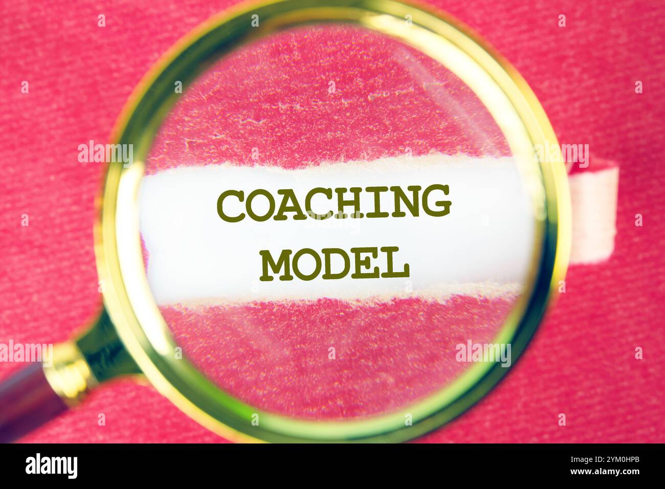 Business concept. The phrase, text,and words of the COACHING MODEL written on through a ...