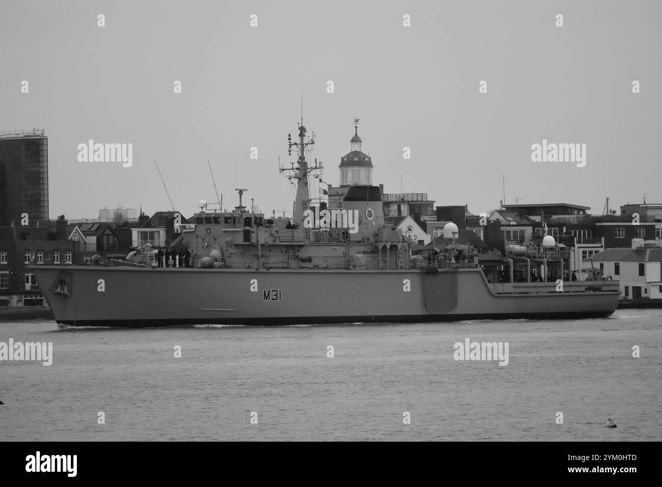 Grayscale. Passing the Old Portsmouth waterfront. HMS Cattistock, a ...