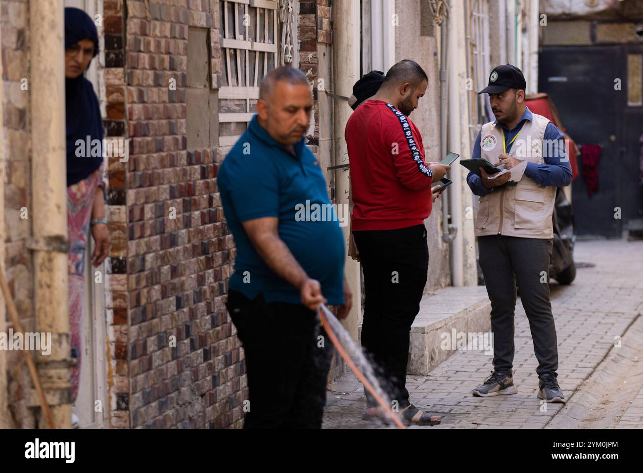 A worker, right, prepares to collect information from the public as ...