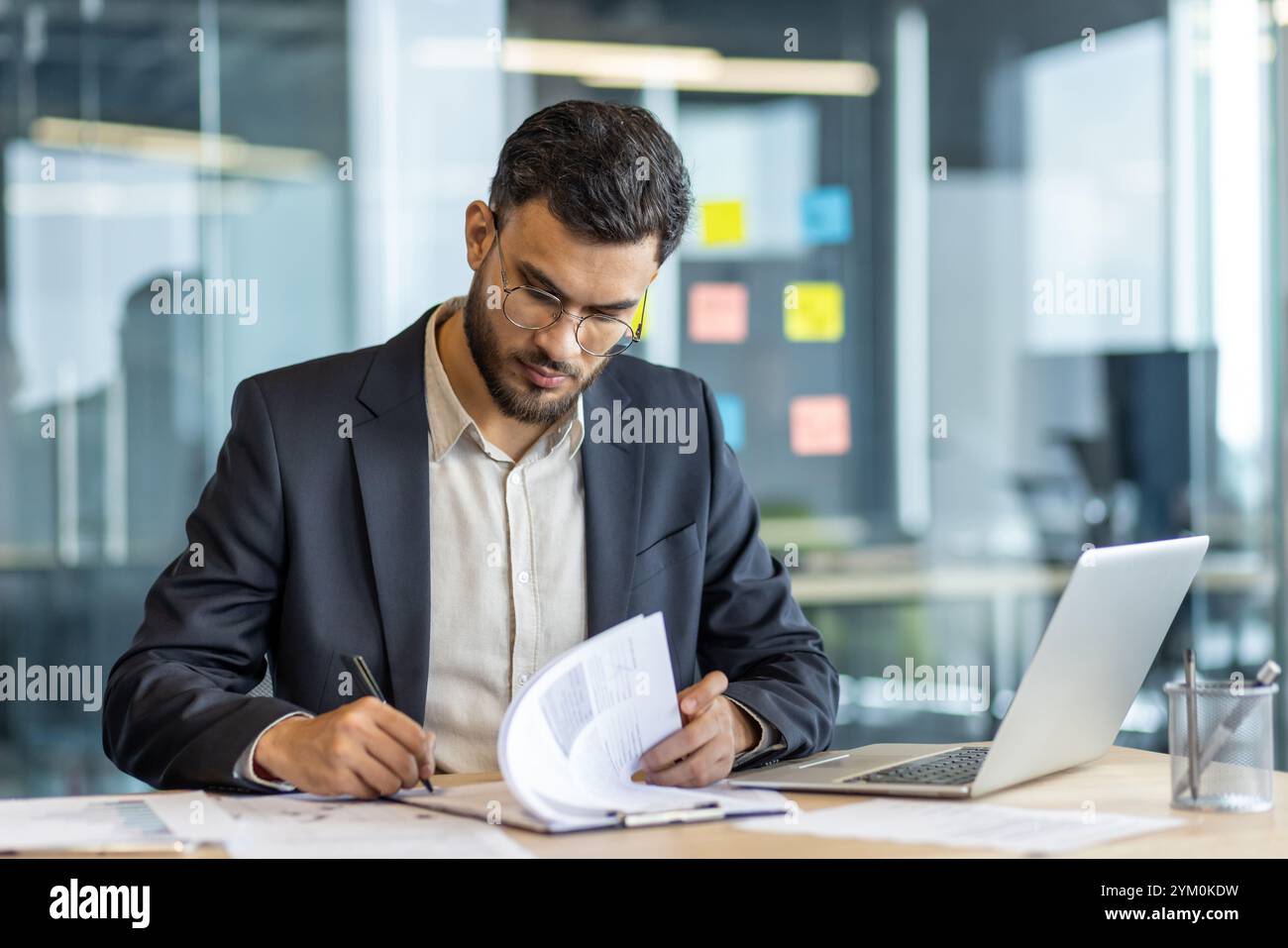 Professional in office signs contracts with focused attention and ...