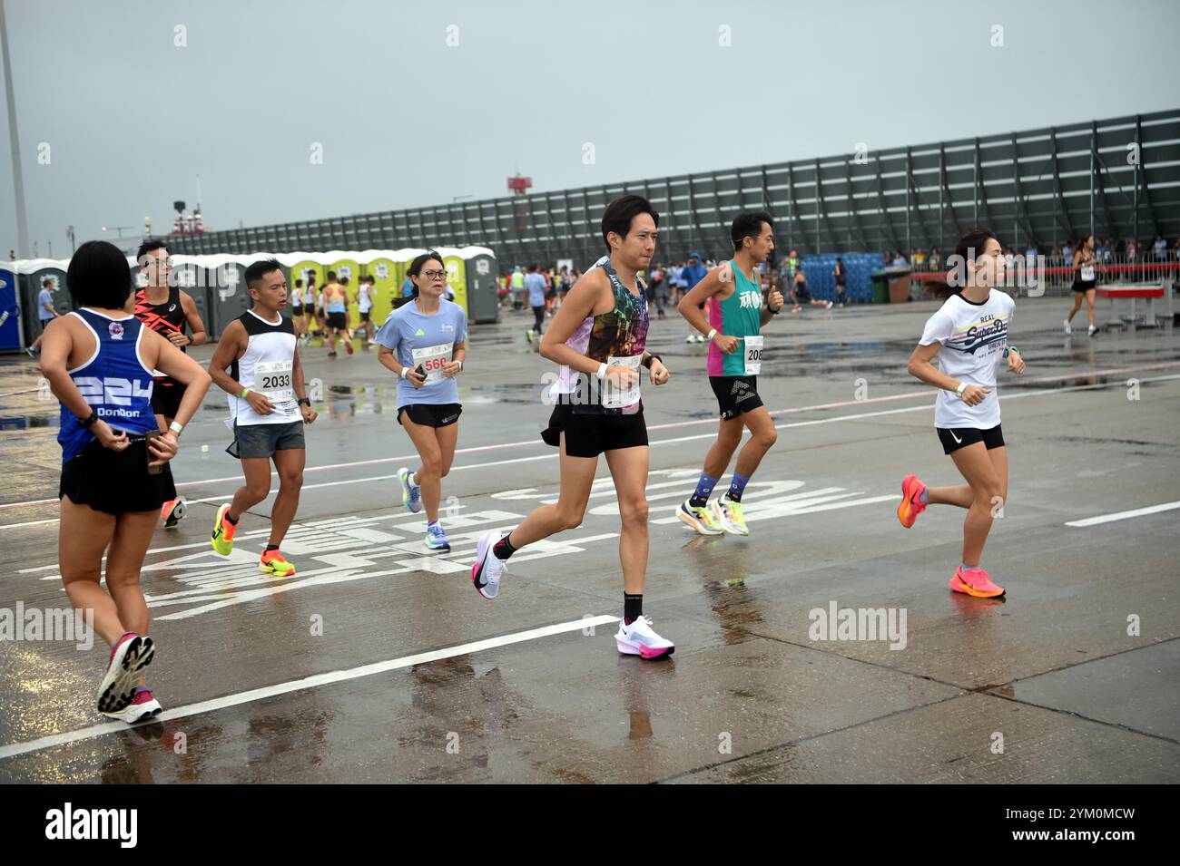 People participate in a running event to celebrate the upcoming launch ...