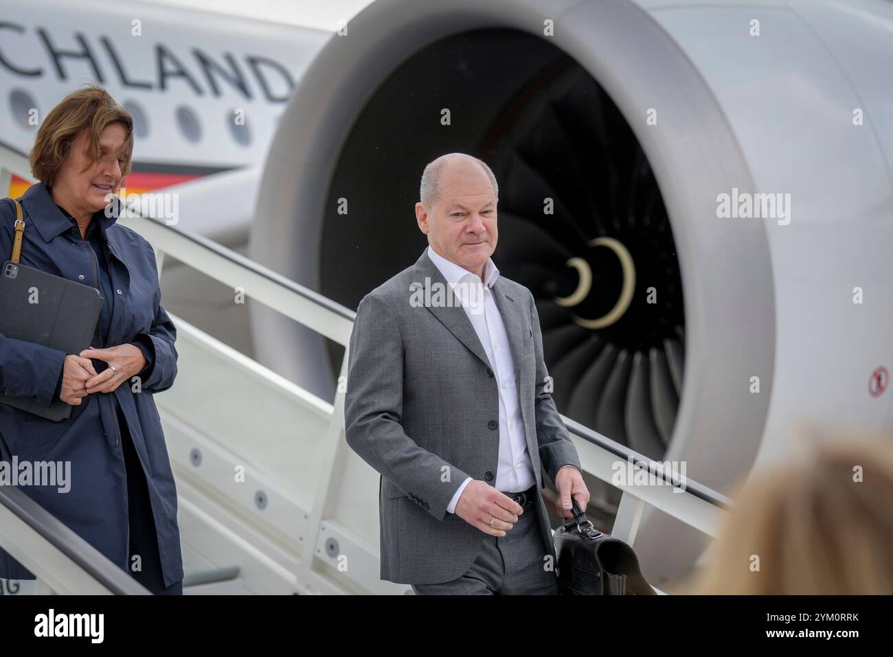 German Chancellor Olaf Scholz, right, and his wife Britta Ernst walk ...