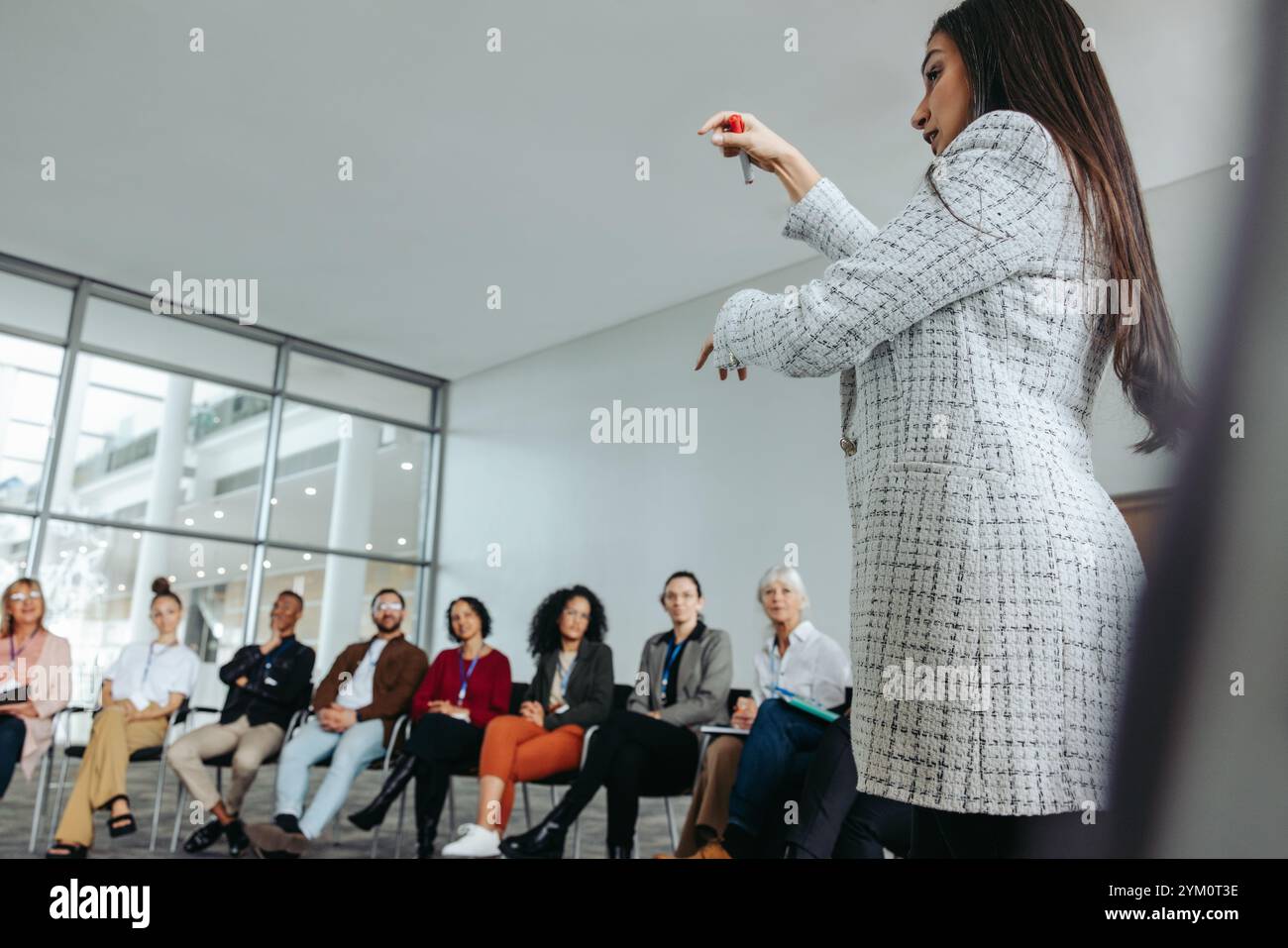 Female professional delivering a presentation at an office event ...