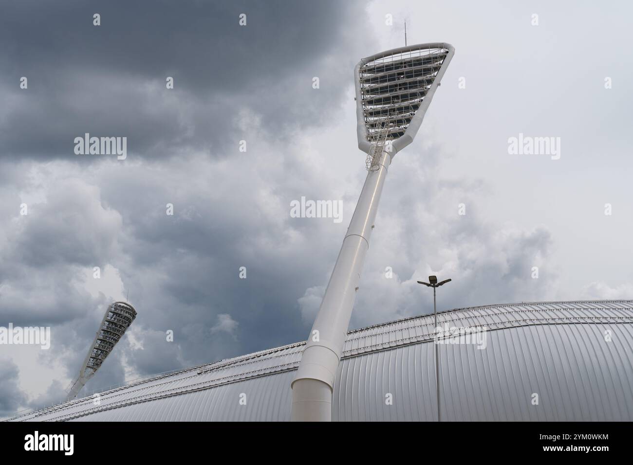 Tall, sleek lighting towers extend above the stadium, showcasing modern ...