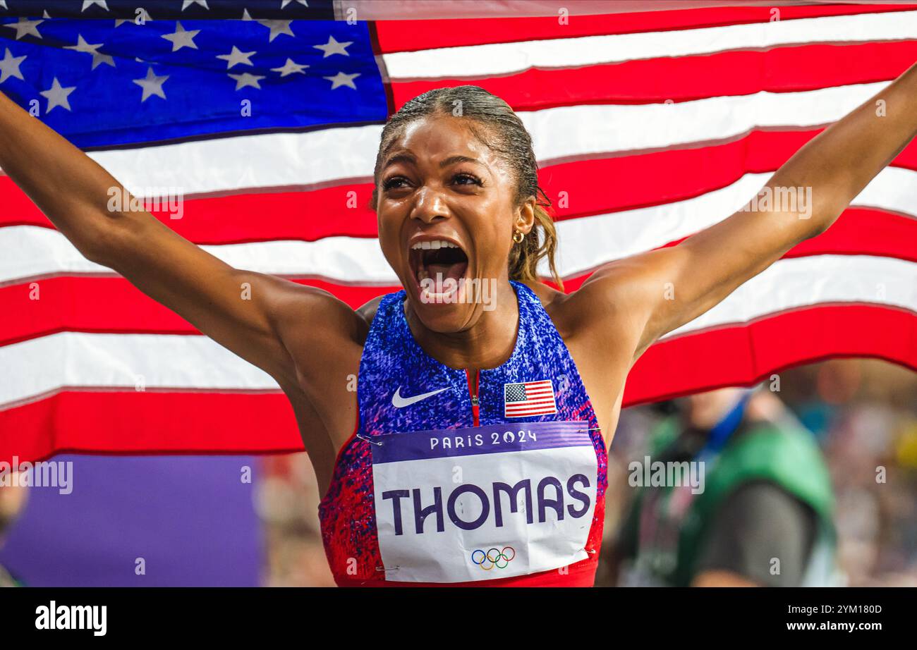 Gabrielle Thomas celebrating with her country's flag in the 200 meters ...