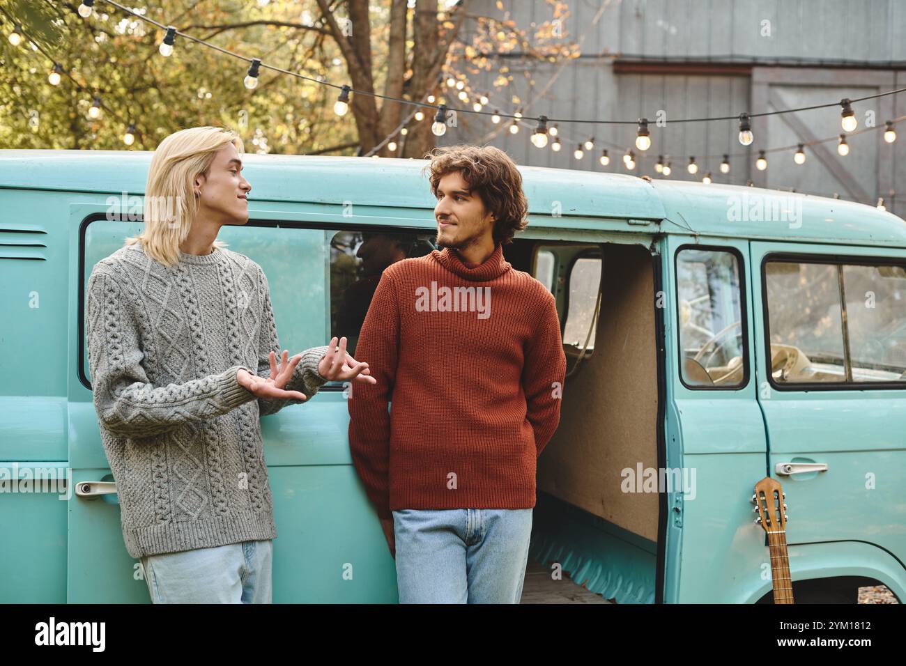 Two young and handsome people engage in a lively conversation beside a ...